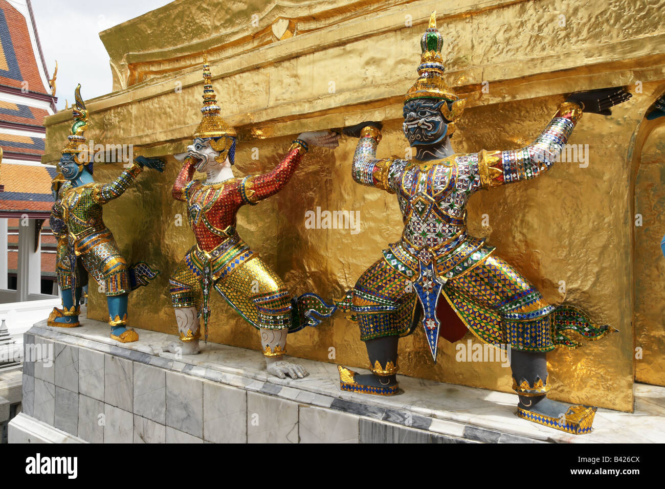 Three Fierce Figures of mythical beings on Temple Stock Photo - Alamy