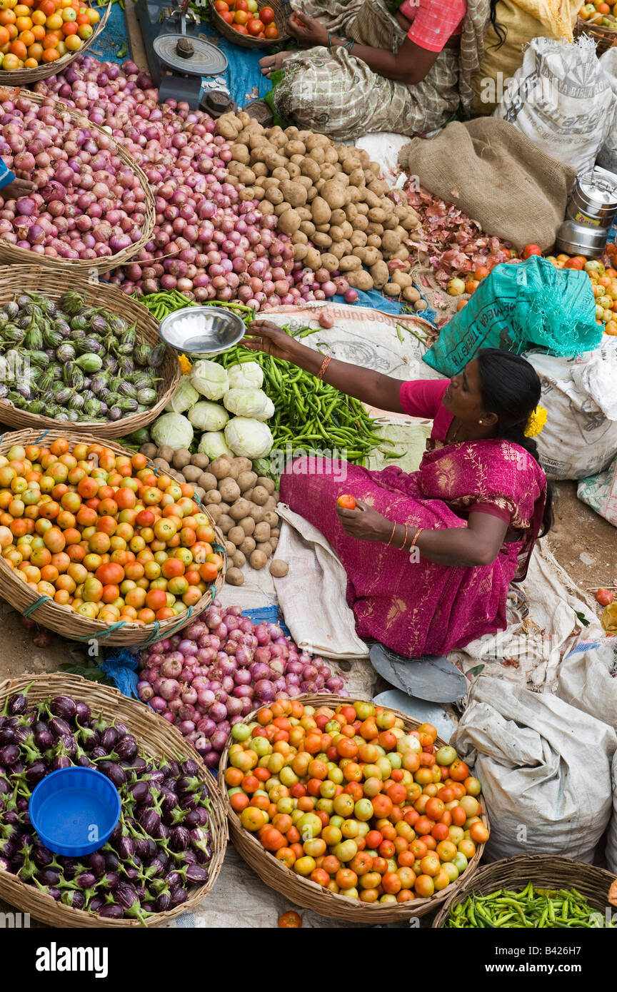 Indian woman selling vegetables at a local india market in the town of Puttaparthi, Andhra ...