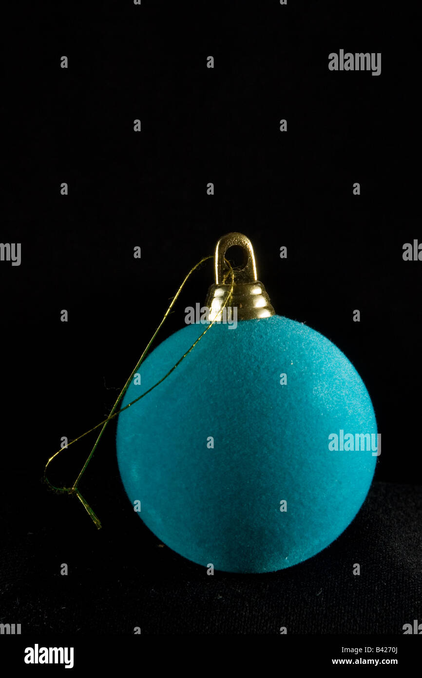 A sky blue fuzzy christmas ball ornament or decoration with a gold ...