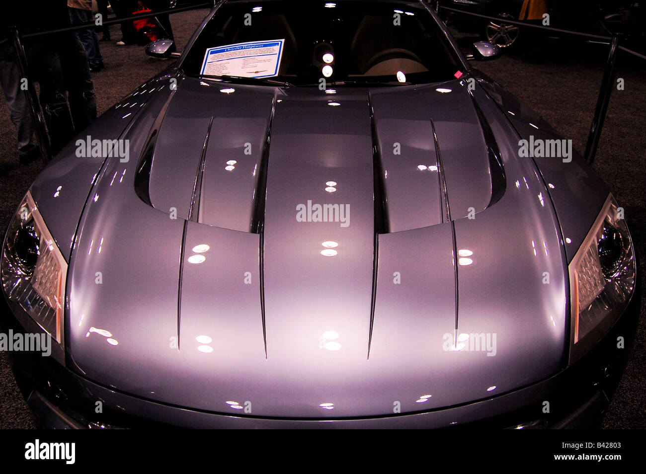 Shiny front view of a new car under the lights at an auto show Stock ...