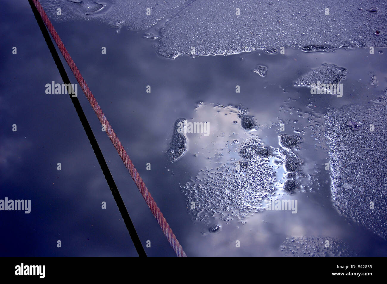Sky and clouds reflecting off a partially frozen lake Stock Photo - Alamy