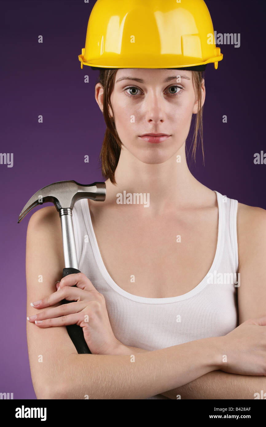 Female model wearing a hard hat and holding a claw hammer Stock Photo ...