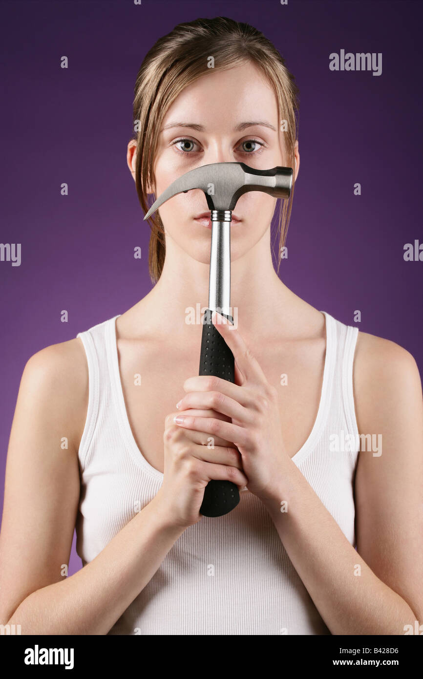 “Female model hoding a claw hammer” Stock Photo - Alamy