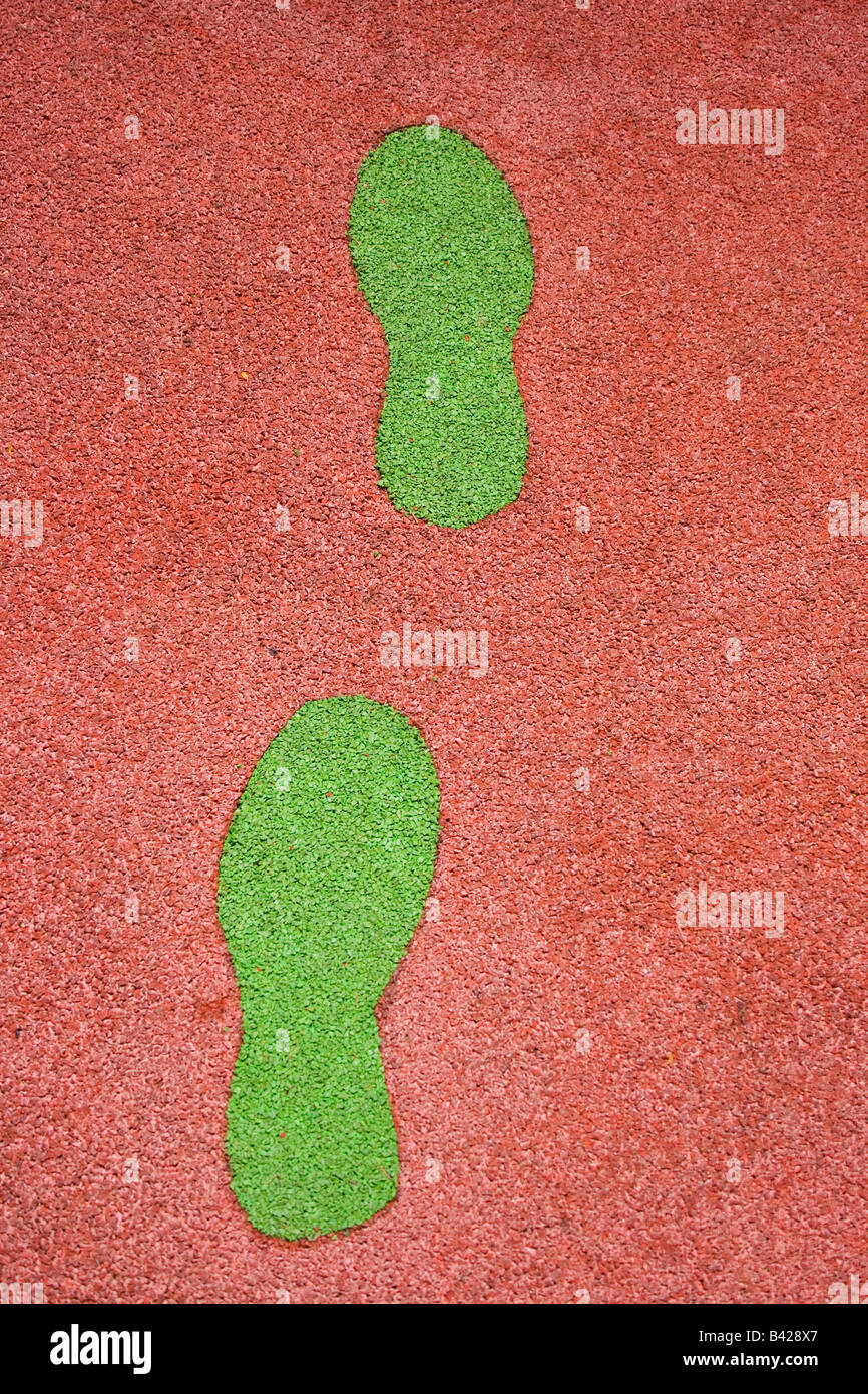 Green footsteps on red background Stock Photo - Alamy