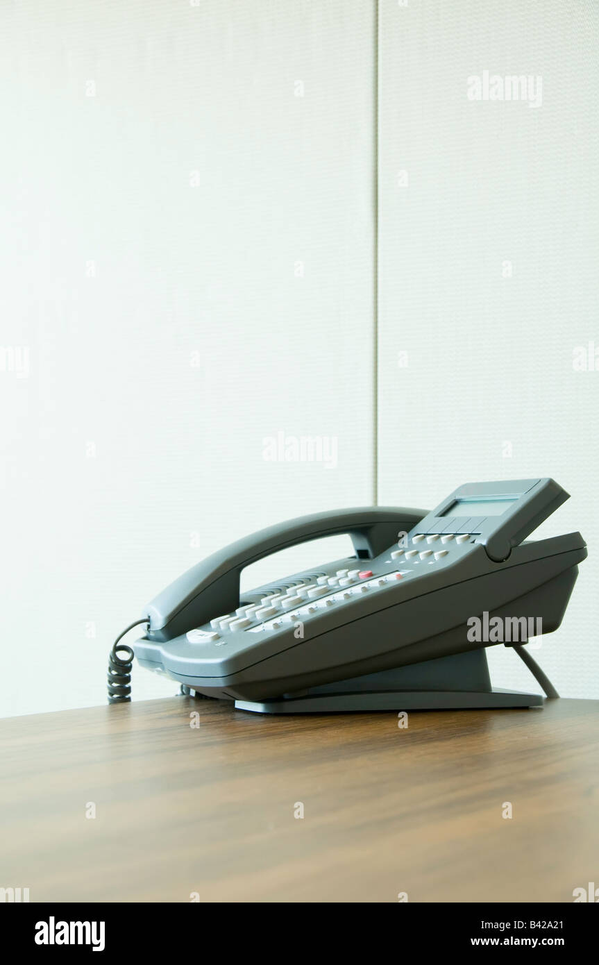 Office telephone at corner of desk Stock Photo - Alamy