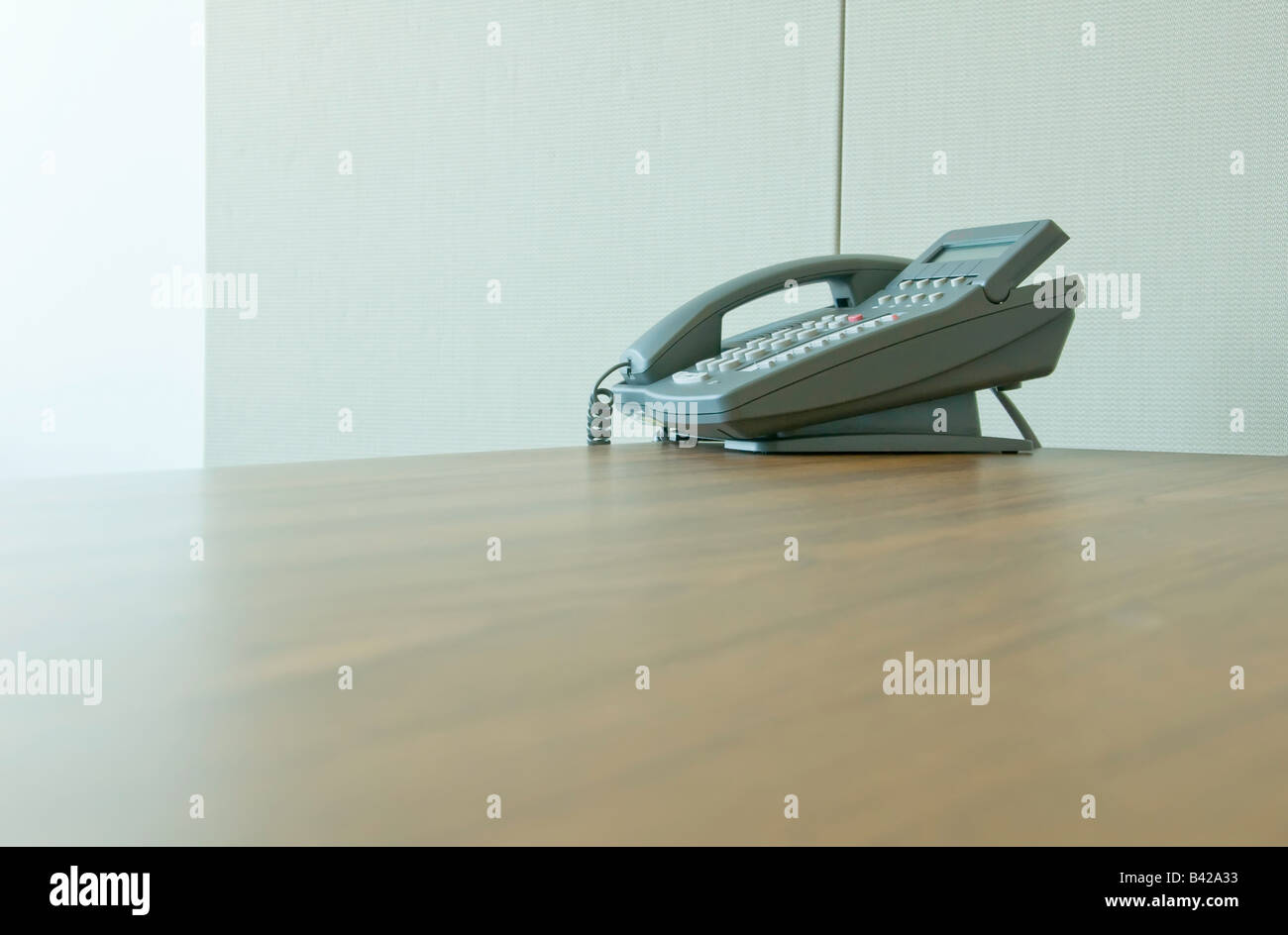 Office telephone at corner of desk facing a bright window Stock Photo ...
