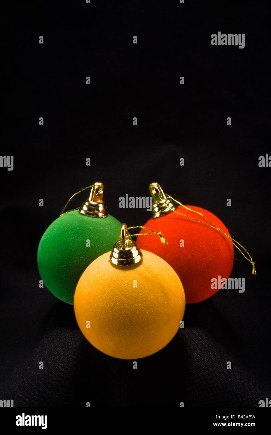 A group of green yellow and red fuzzy christmas ball ornaments with ...