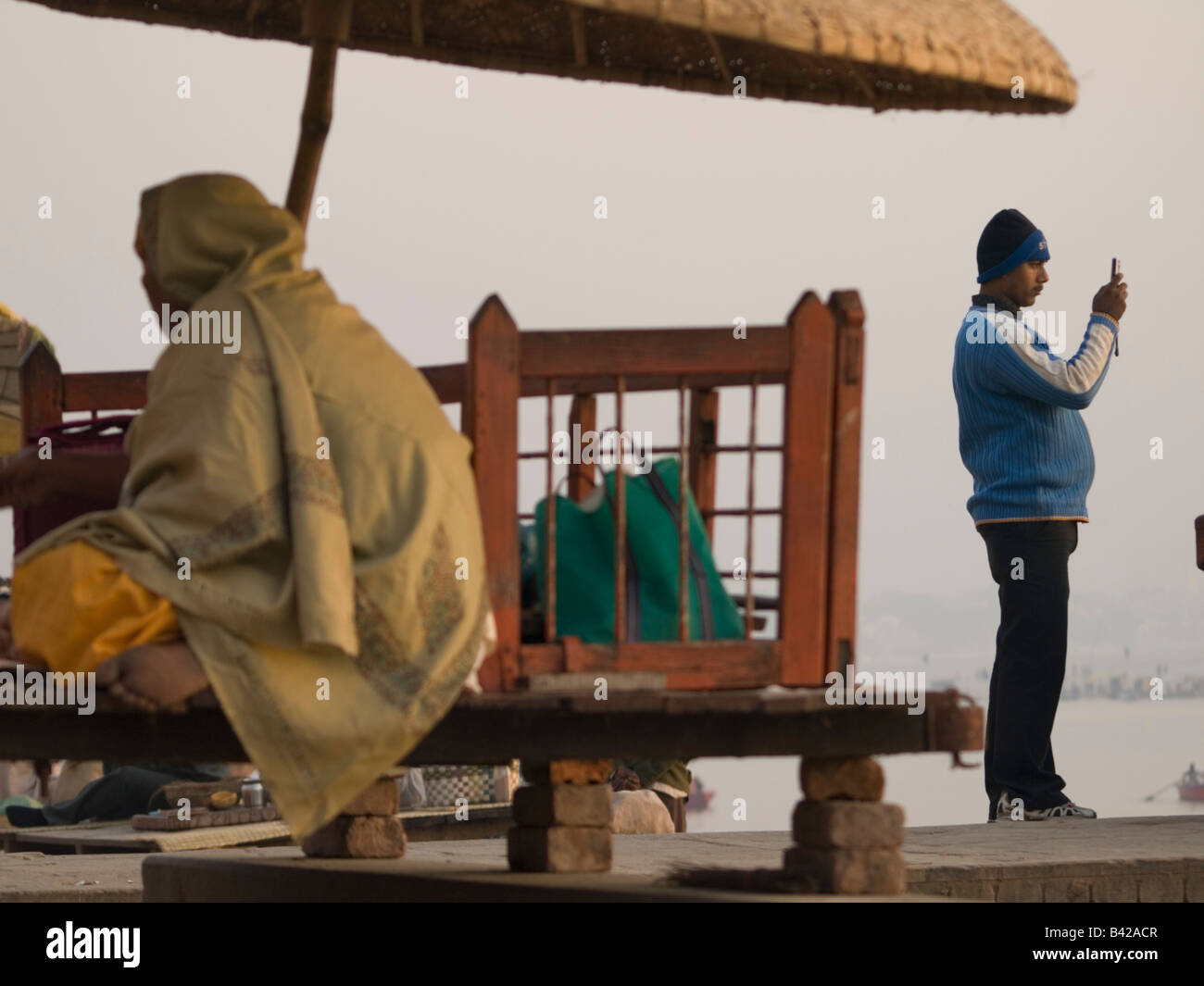 Pilgrims take cell phone pictures on the shore of the holy river Ganges ...