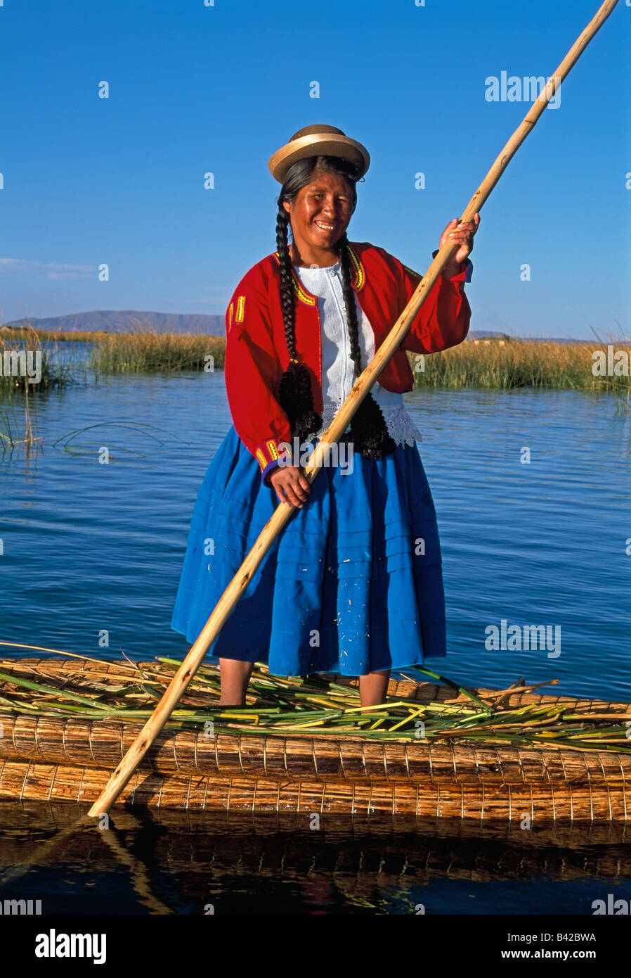 Uros Indian woman in traditional reed boat, Islas Flotantes, Lake ...