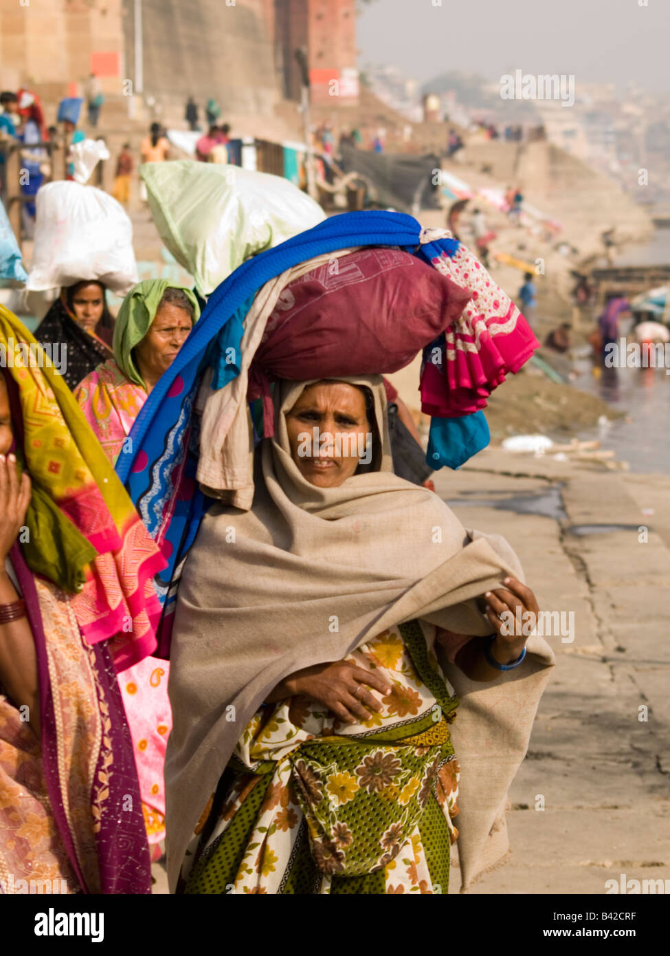 Pilgrims walking along the holy river Ganges an important pilgrimage ...