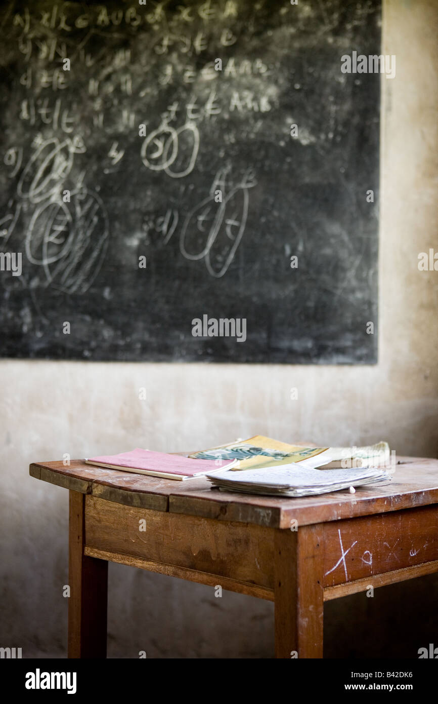 A much used chalkboard and desk in a Rwandan classroom Stock Photo - Alamy
