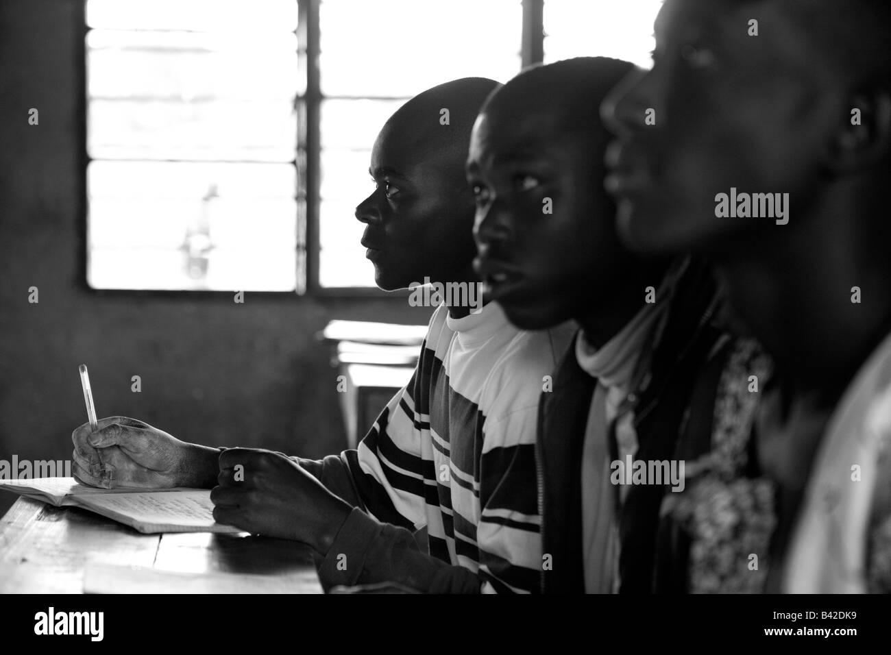 Rwandan secondary students listen attentively in their boarding school ...