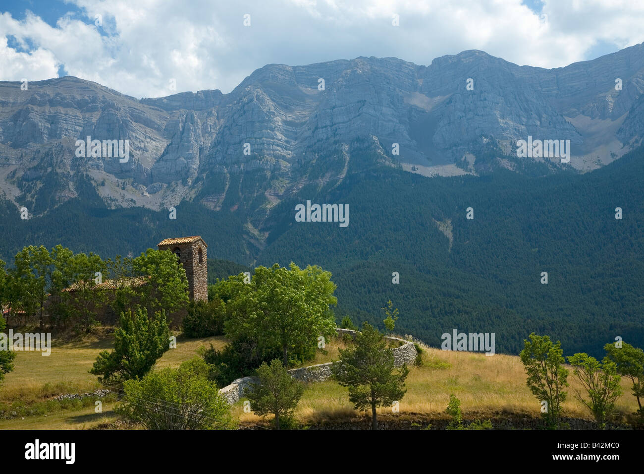 Old church tower and blue sky in Pyrenees Mountains, near La Seu d ...