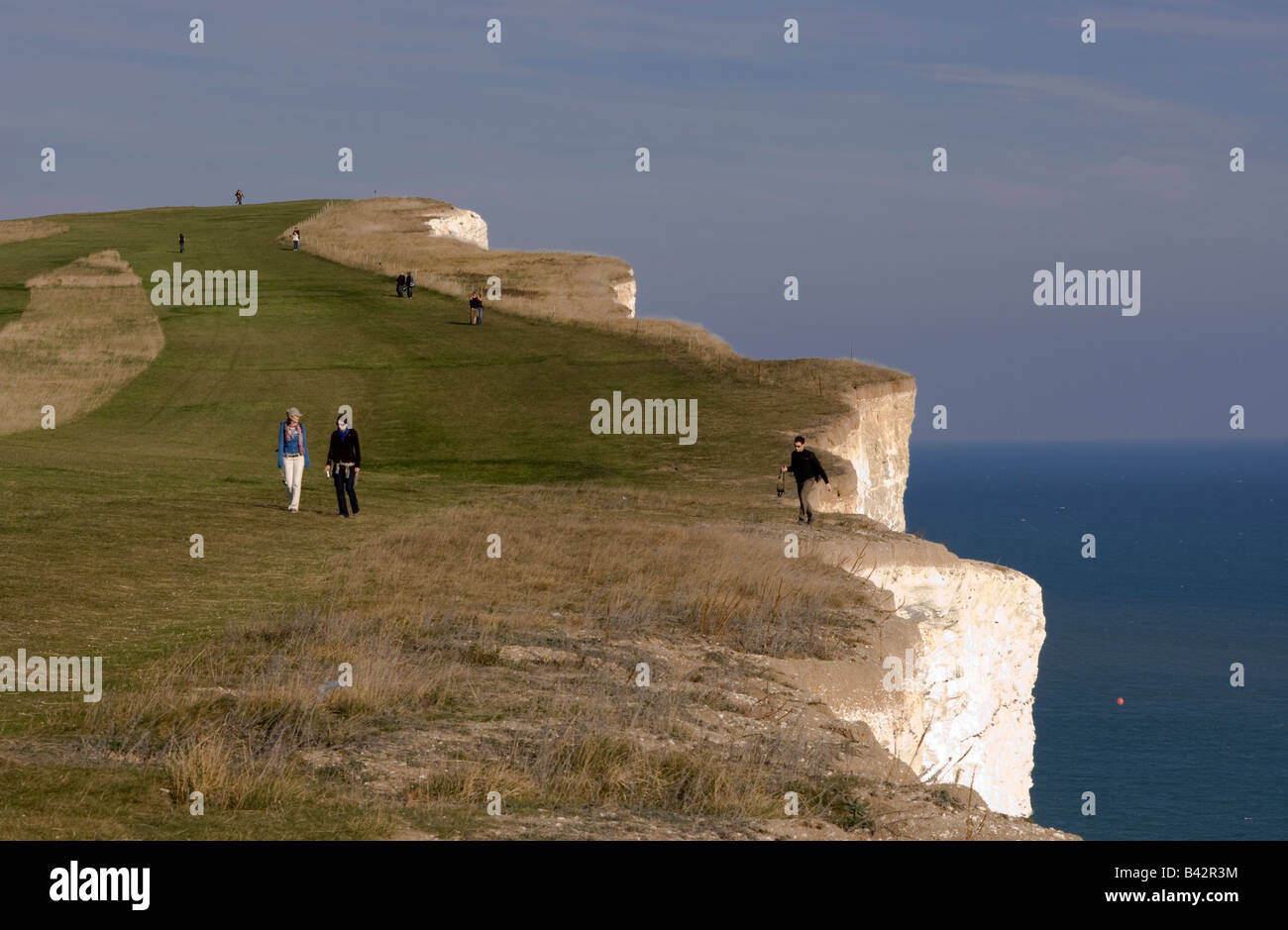 Sightseers walk along the cliff edge at Beachy Head – a notorious ...