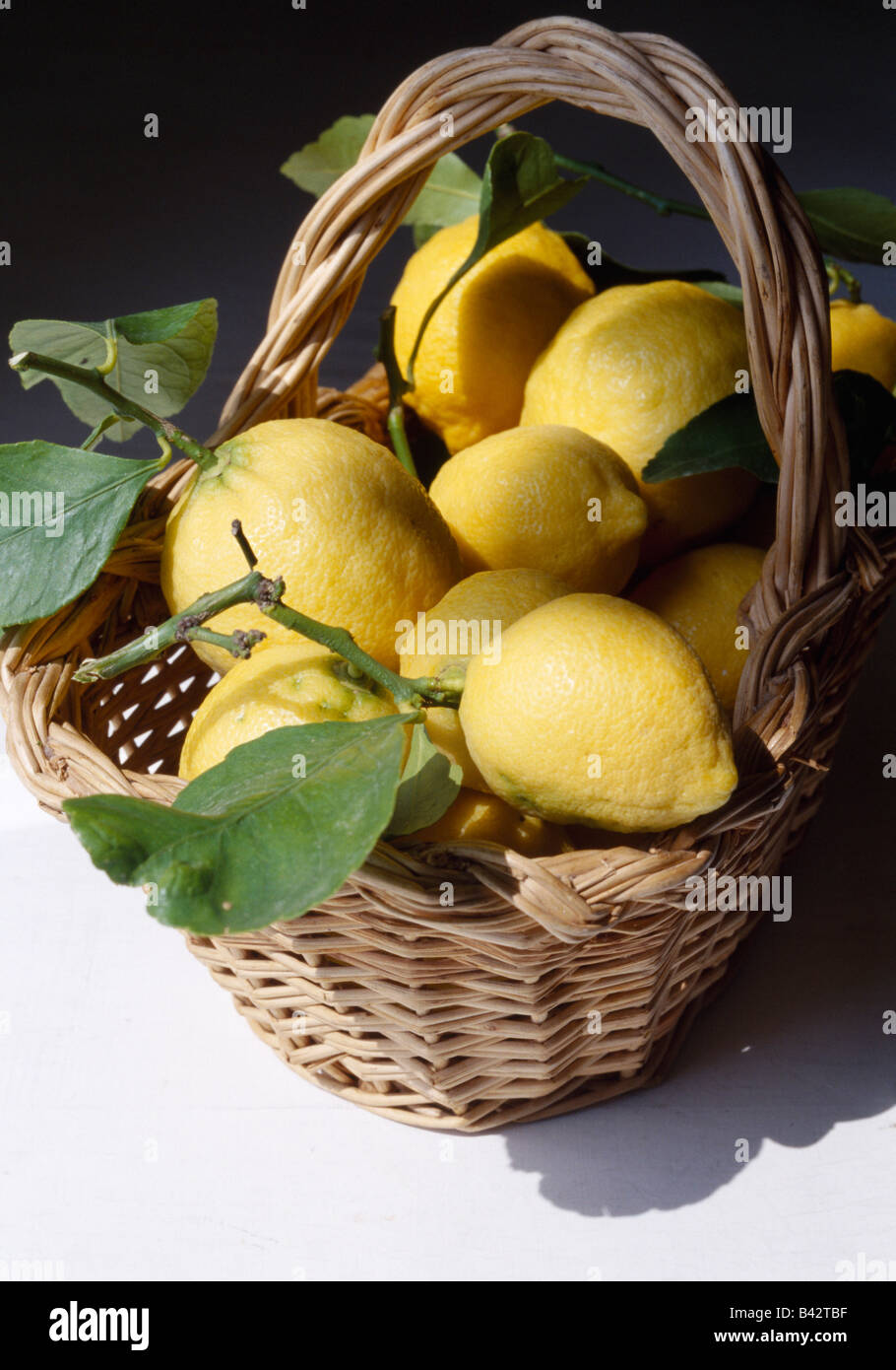 Lemons in a basket Stock Photo - Alamy