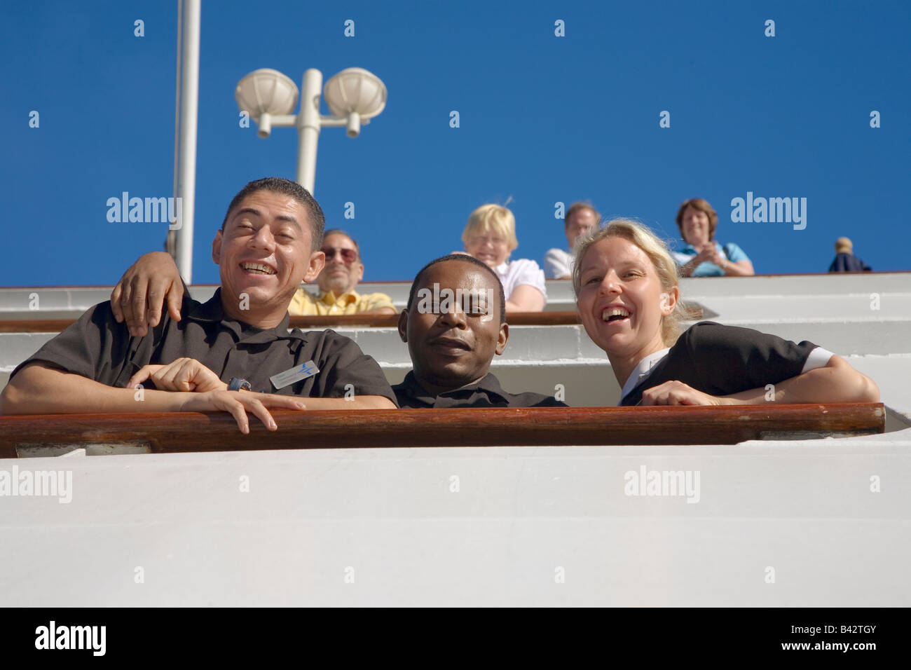 Cruise ship crew looking down from top of Insignia Oceania Cruise ship ...