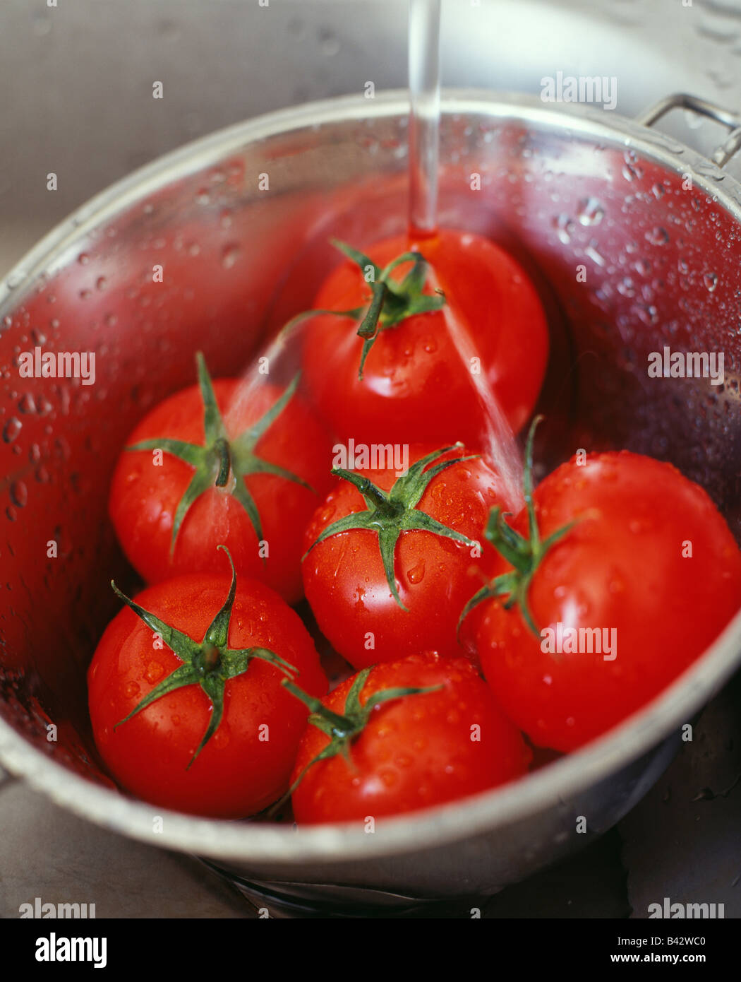 Tomatoes in colander Stock Photo - Alamy