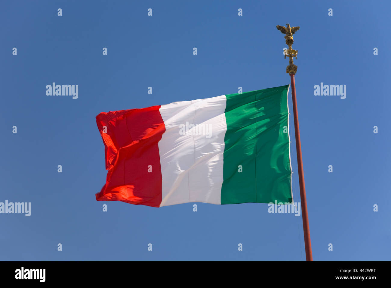 Italian flag flying in blue sky, Rome, Italy, Europe Stock Photo - Alamy