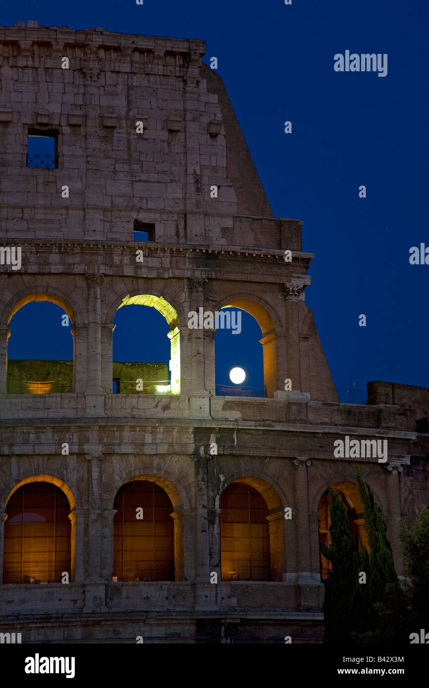 Full moon rising over the Colosseum or Roman Coliseum at dusk ...
