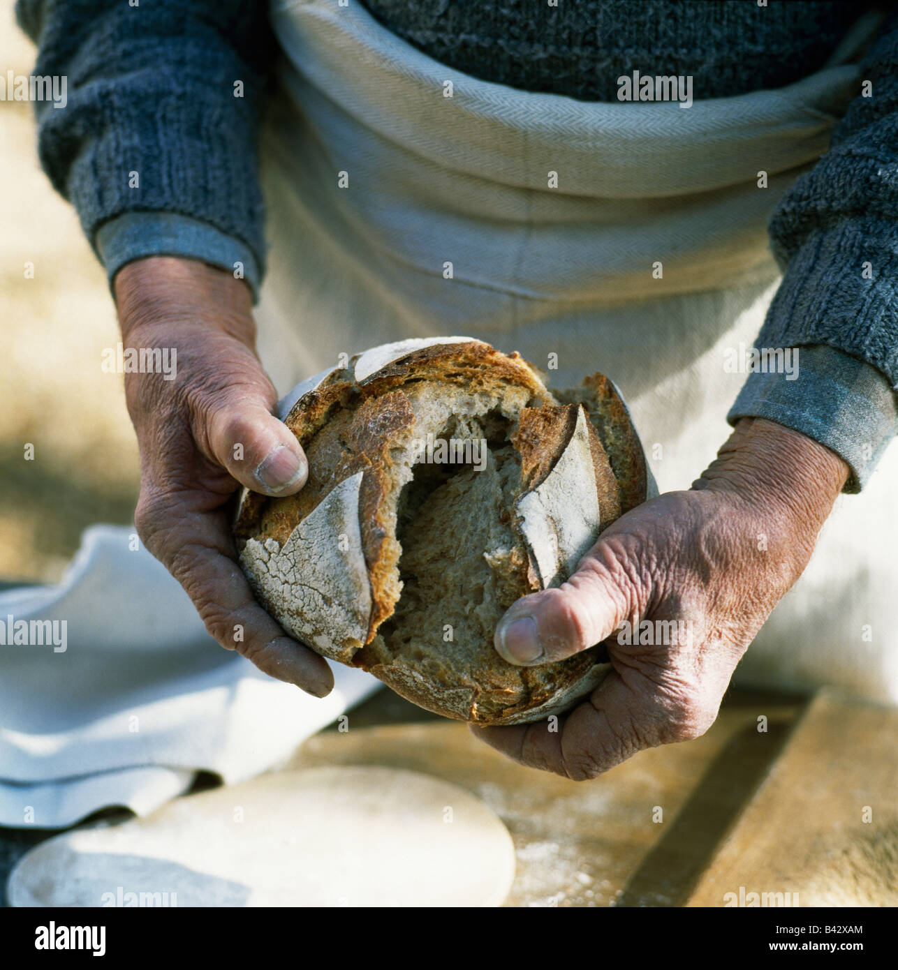 man breaking bread Stock Photo - Alamy