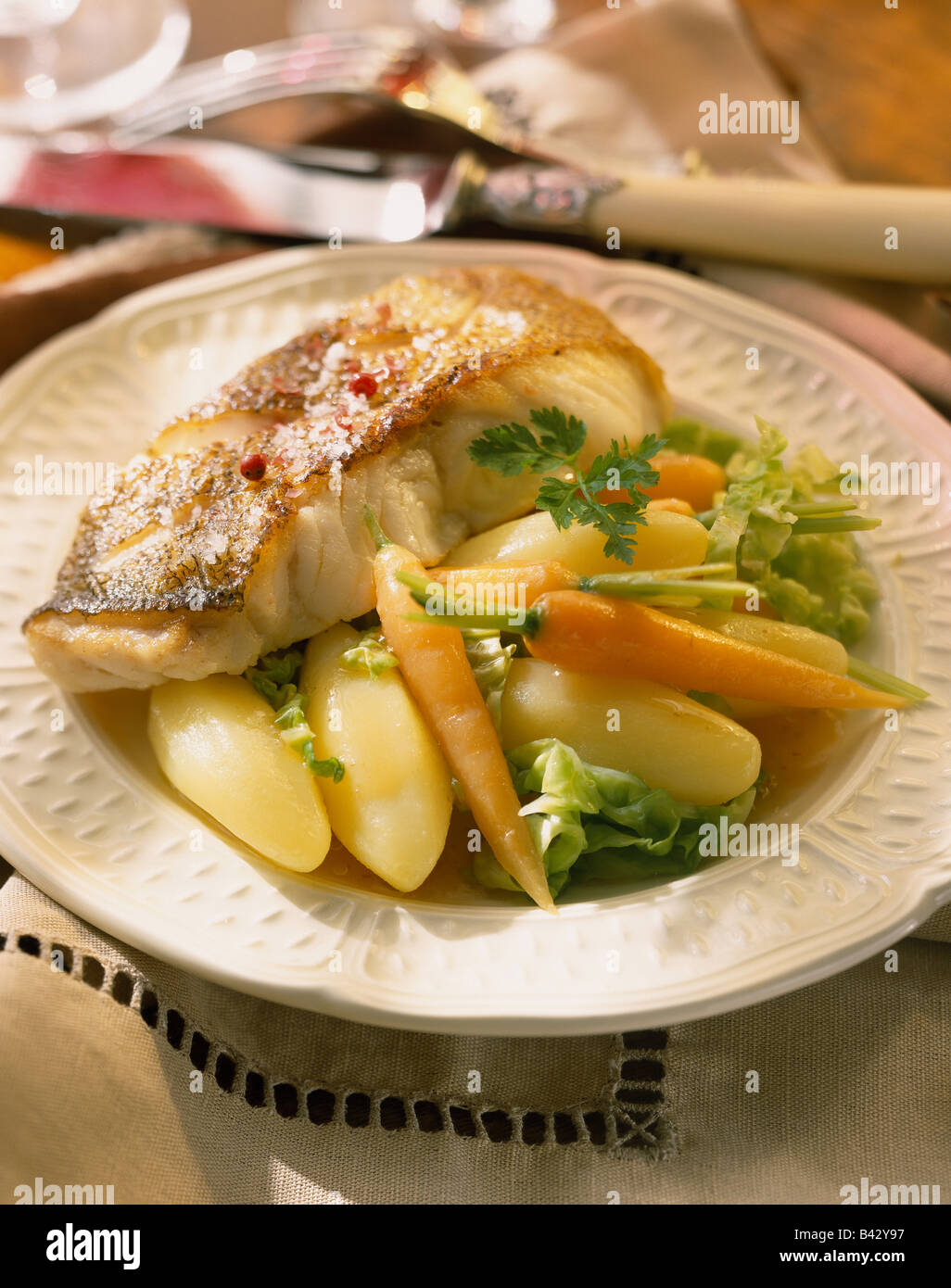 Piece of cod with spring vegetables Stock Photo - Alamy