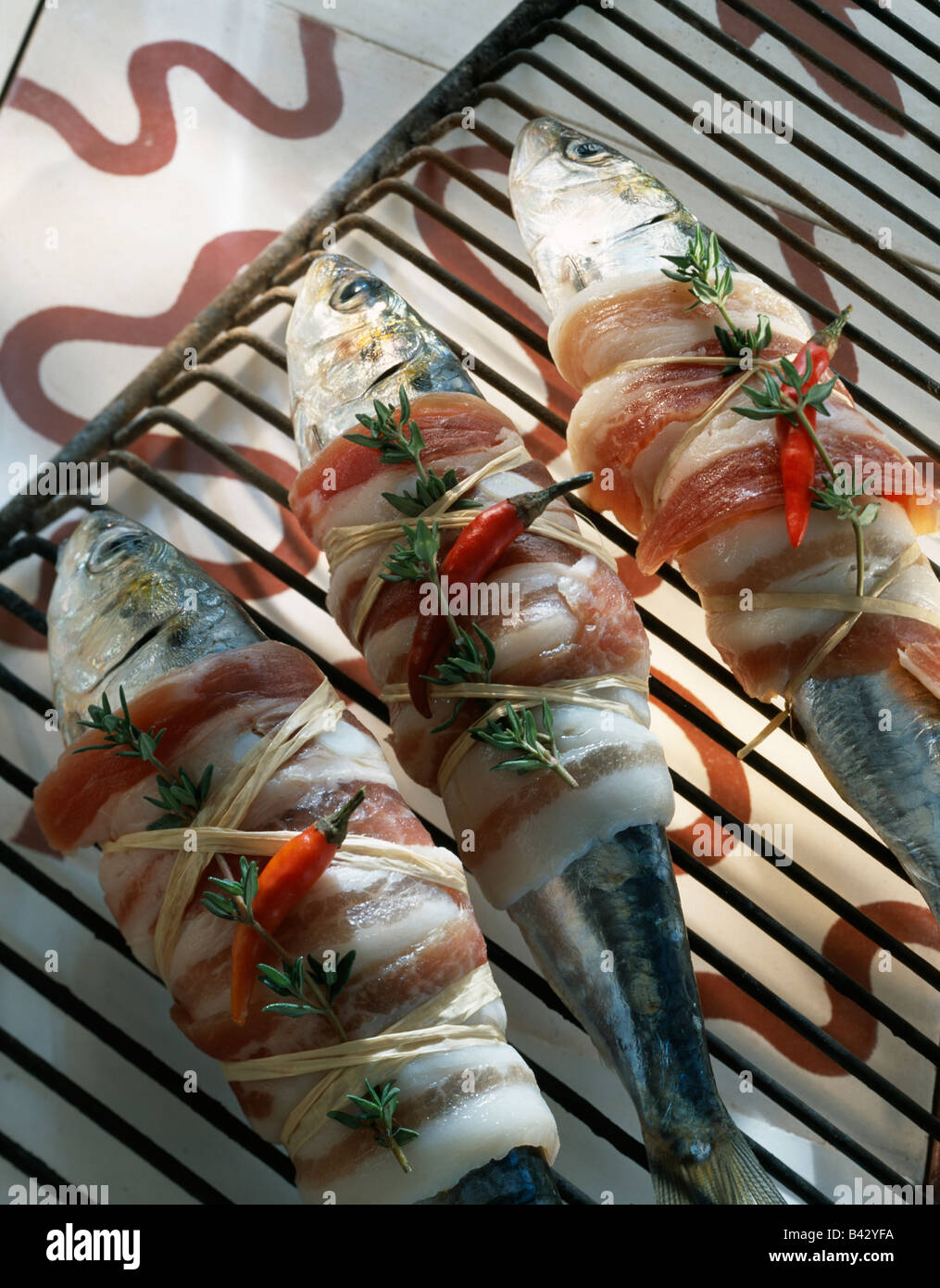 sardines wrapped in bacon ready to be grilled Stock Photo - Alamy