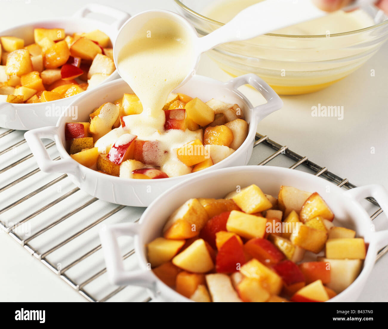 Pouring the sabayon on the fruit Stock Photo - Alamy