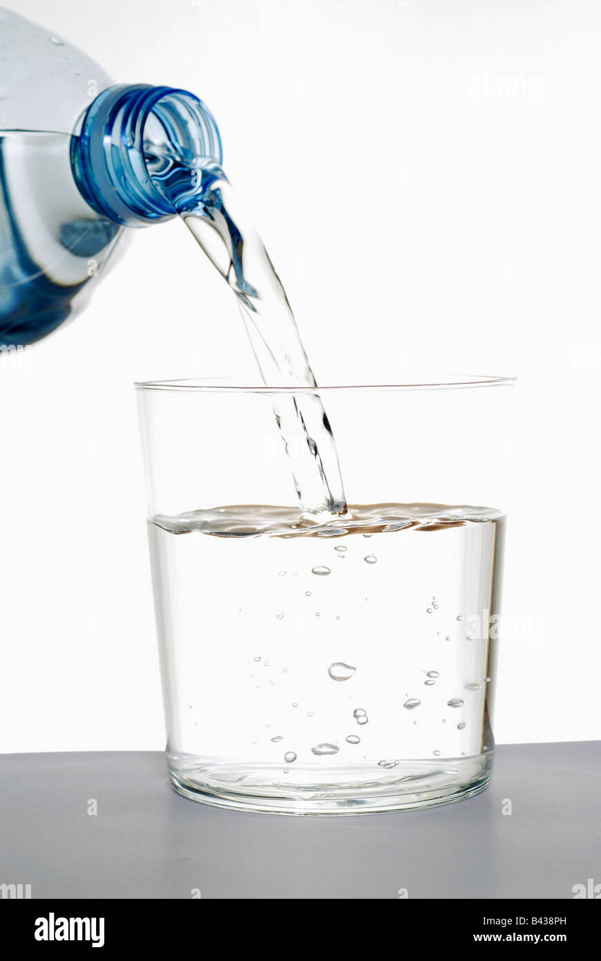 Pouring mineral water into a glass Stock Photo - Alamy