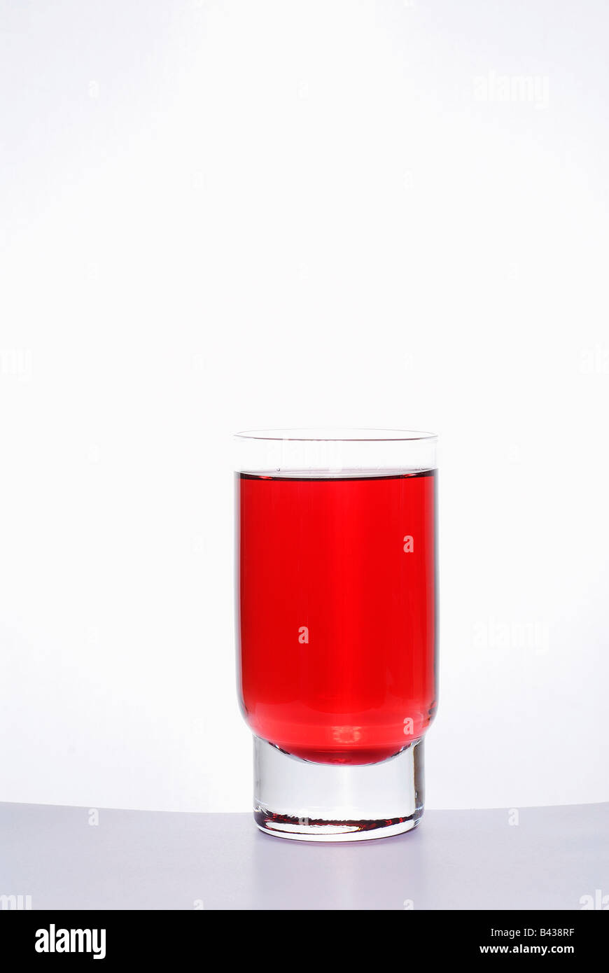 Glass of pomegranate syrup Stock Photo - Alamy
