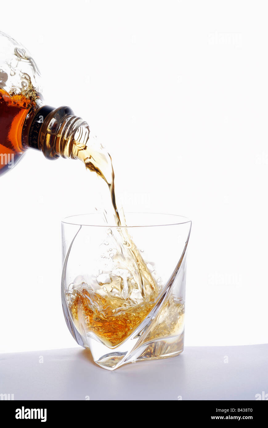 Pouring whiskey into a glass Stock Photo - Alamy