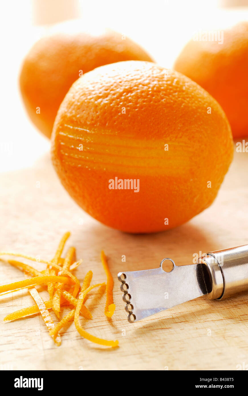 Making orange zests with a zester Stock Photo - Alamy