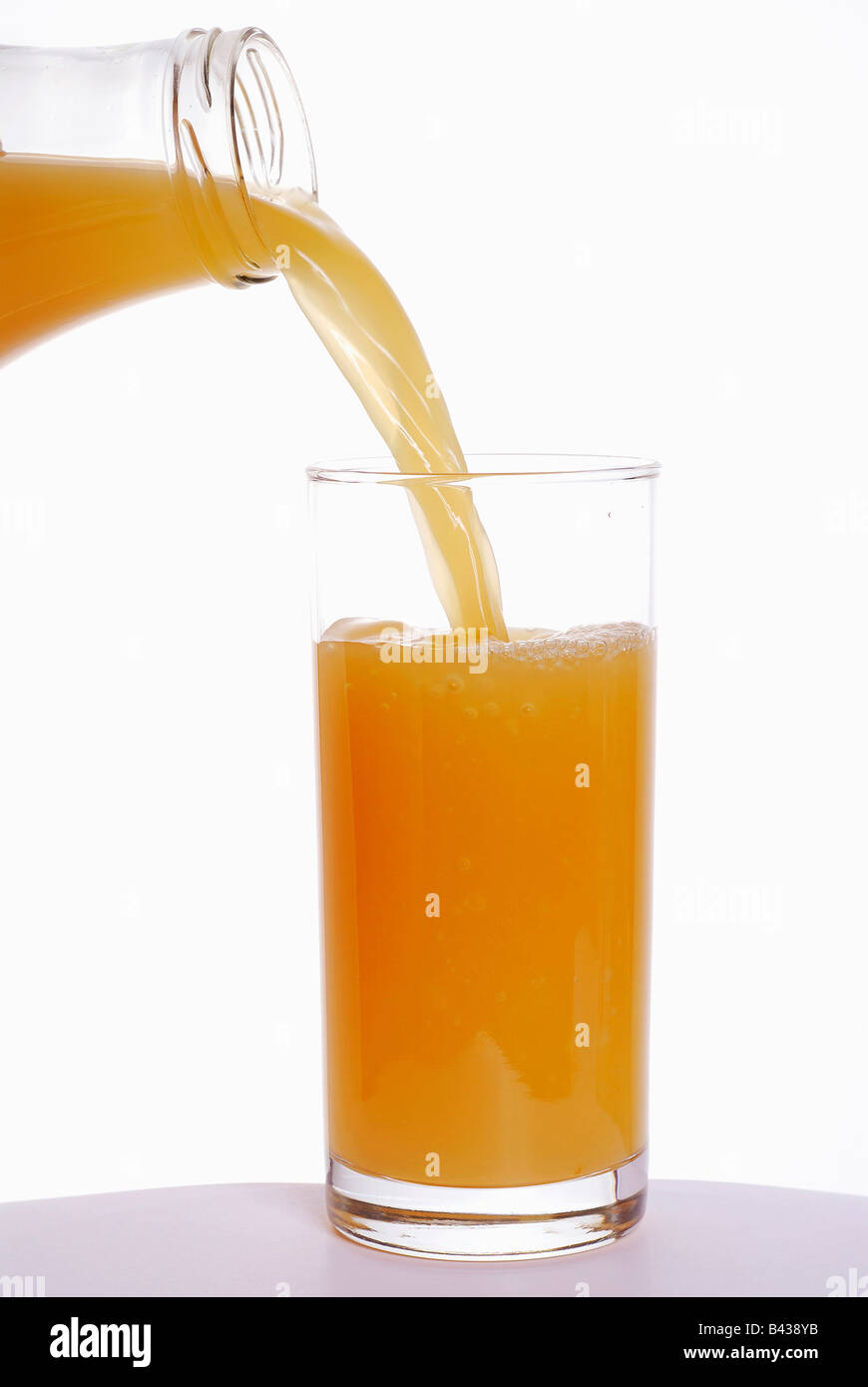 Pouring apple juice into a glass Stock Photo - Alamy