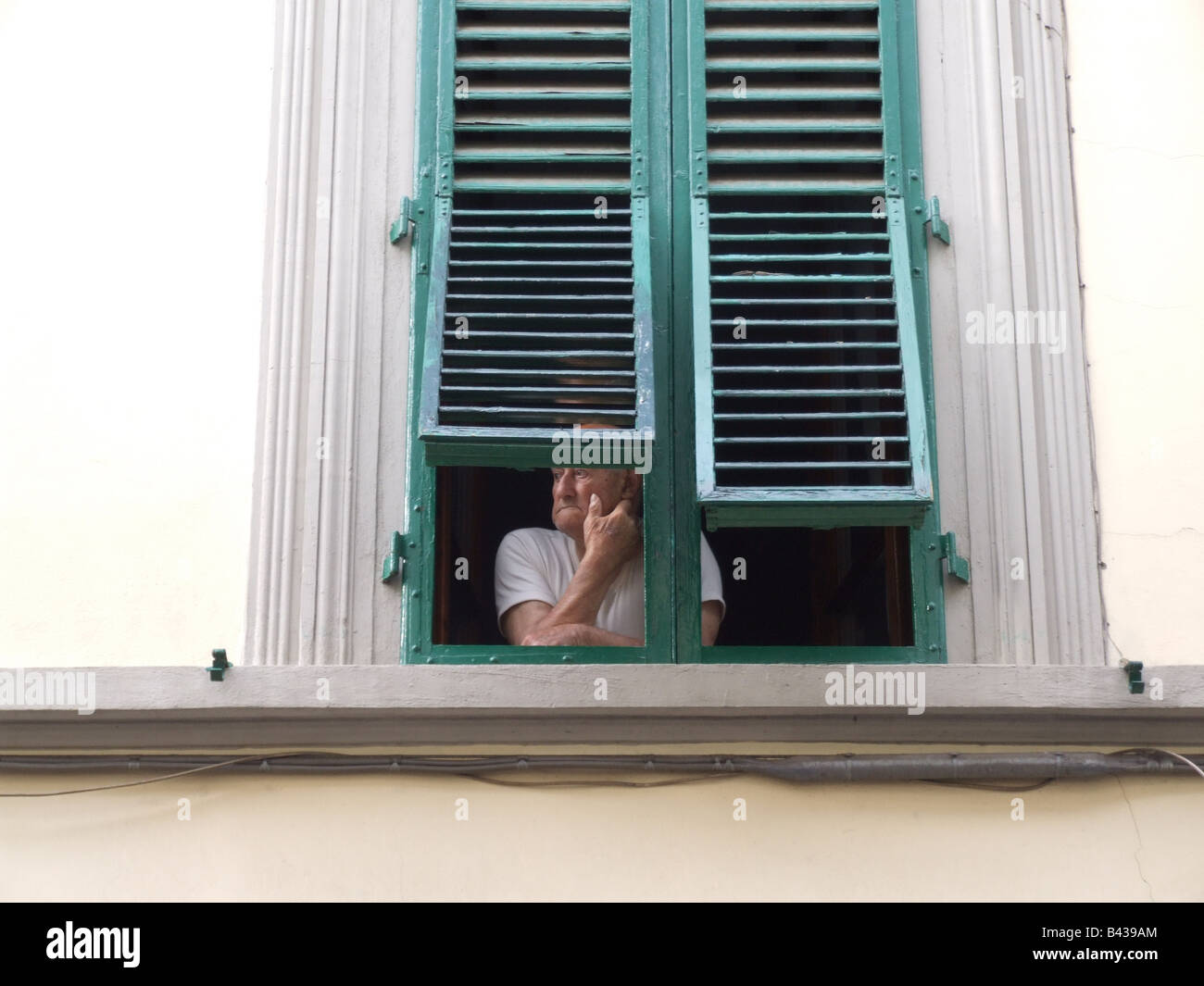 old person looking out of window in italy Stock Photo - Alamy
