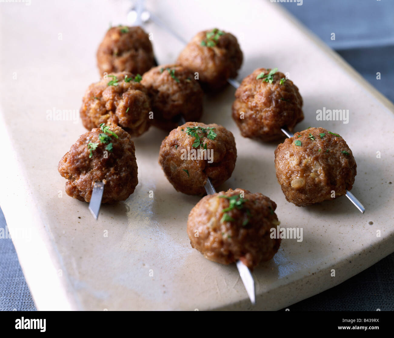 Minced meat balls on skewers Stock Photo - Alamy