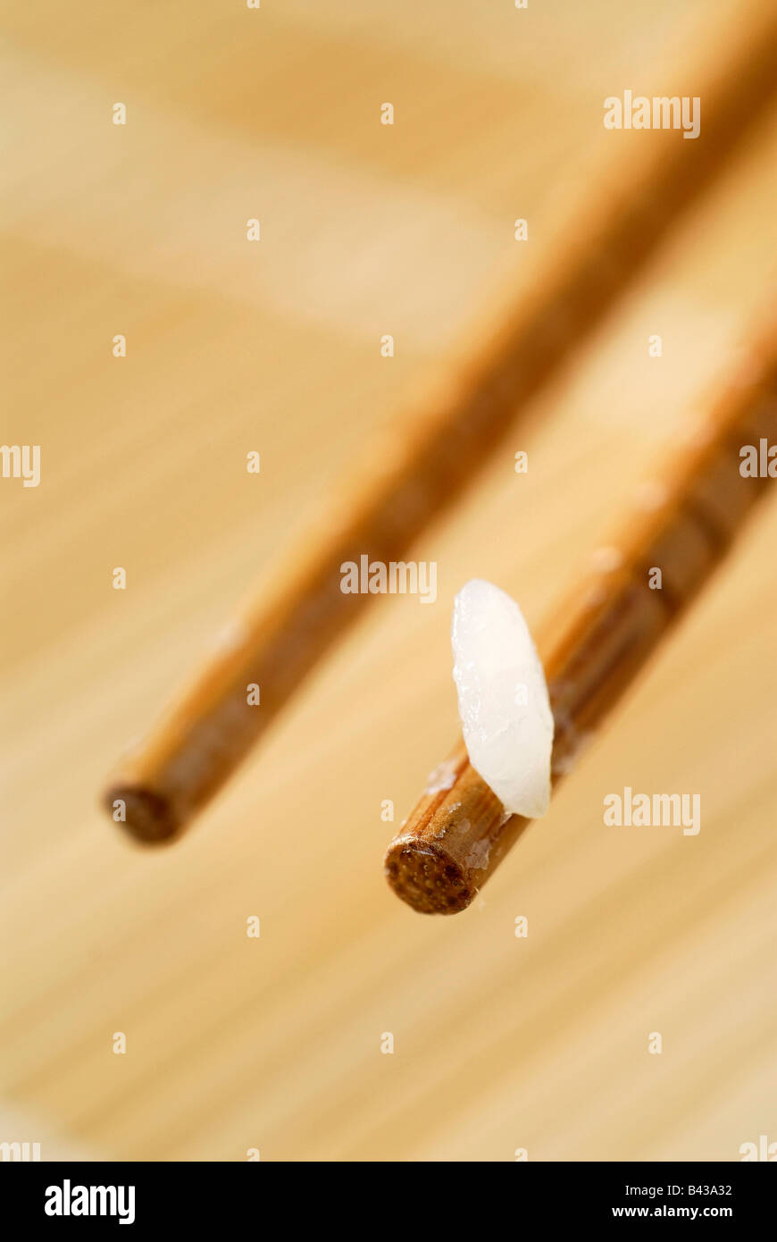 Cooked grain of Japanese rice on chopsticks Stock Photo - Alamy