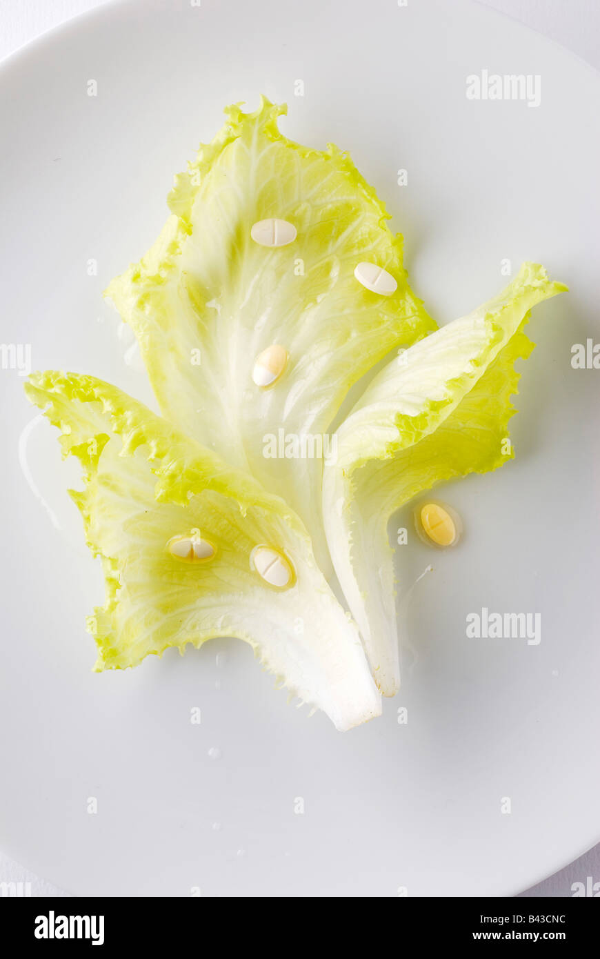 Pills on a lettuce leaf Stock Photo - Alamy