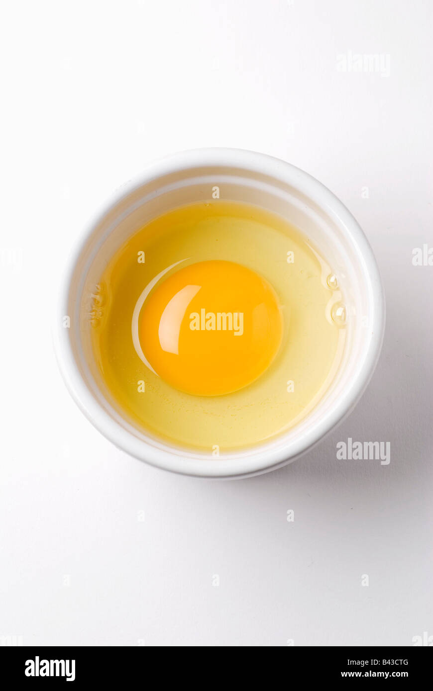 Raw egg in bowl Stock Photo - Alamy