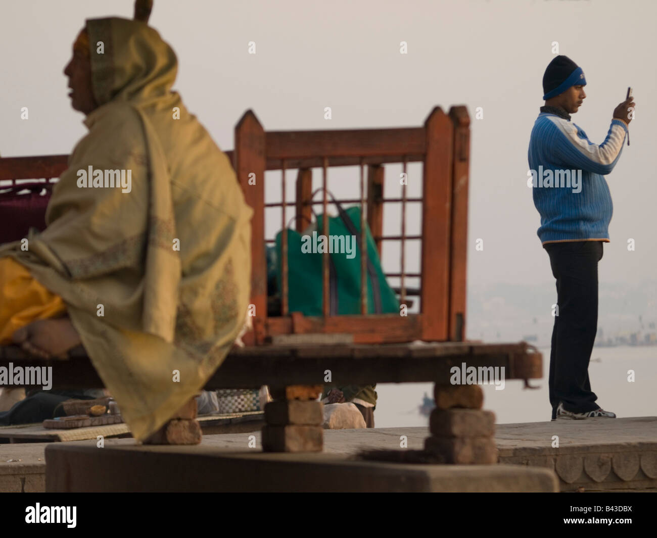 Pilgrims take cell phone pictures on the shore of the holy river Ganges ...