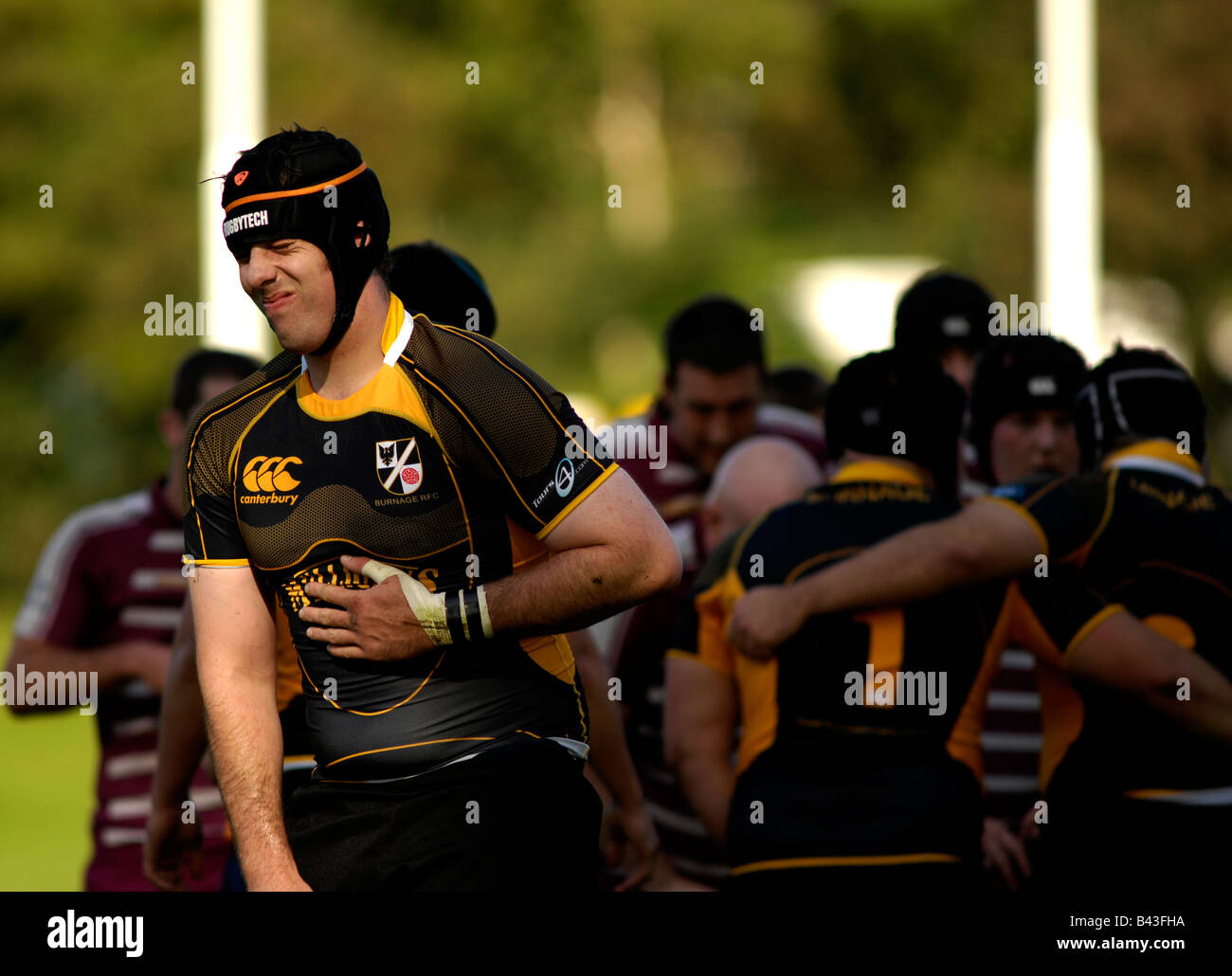 rugby player holds his side after being injured Stock Photo - Alamy