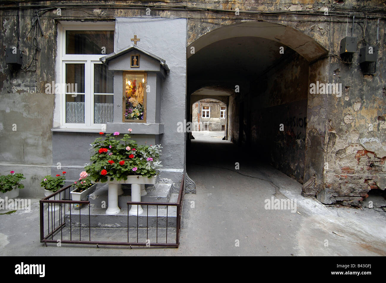 Entrance of a Polish old decrepit housing estate, with its small Virgin ...