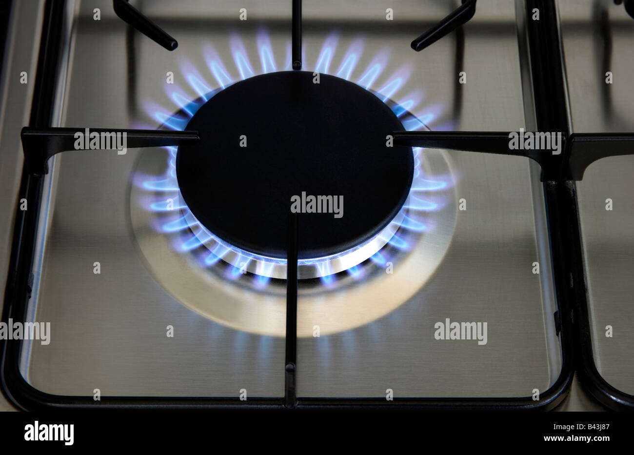 Gas blue flame ring on cooker Stock Photo - Alamy