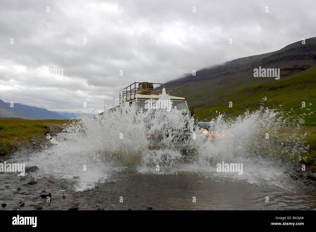 Splashing through a river crossing Stock Photo - Alamy