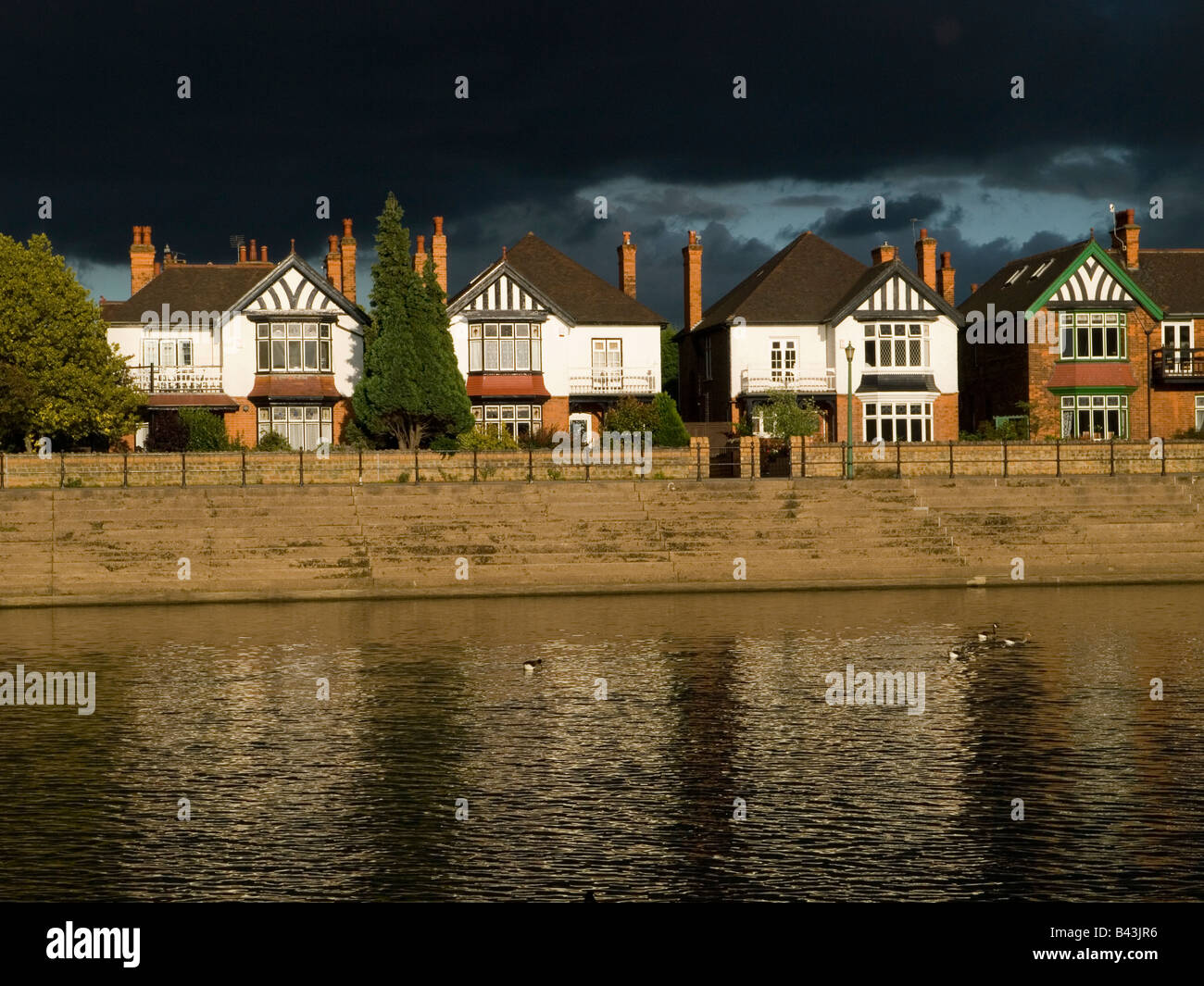A row of houses along the River Trent, on a stormy afternoon in ...