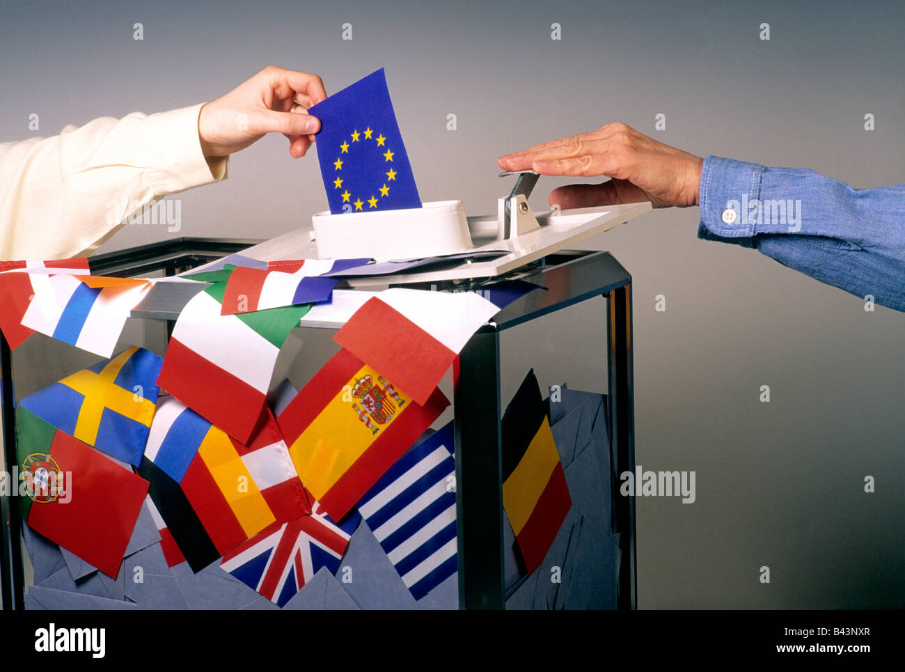 Casting a ballot in a transparent ballot box surrounded by European ...