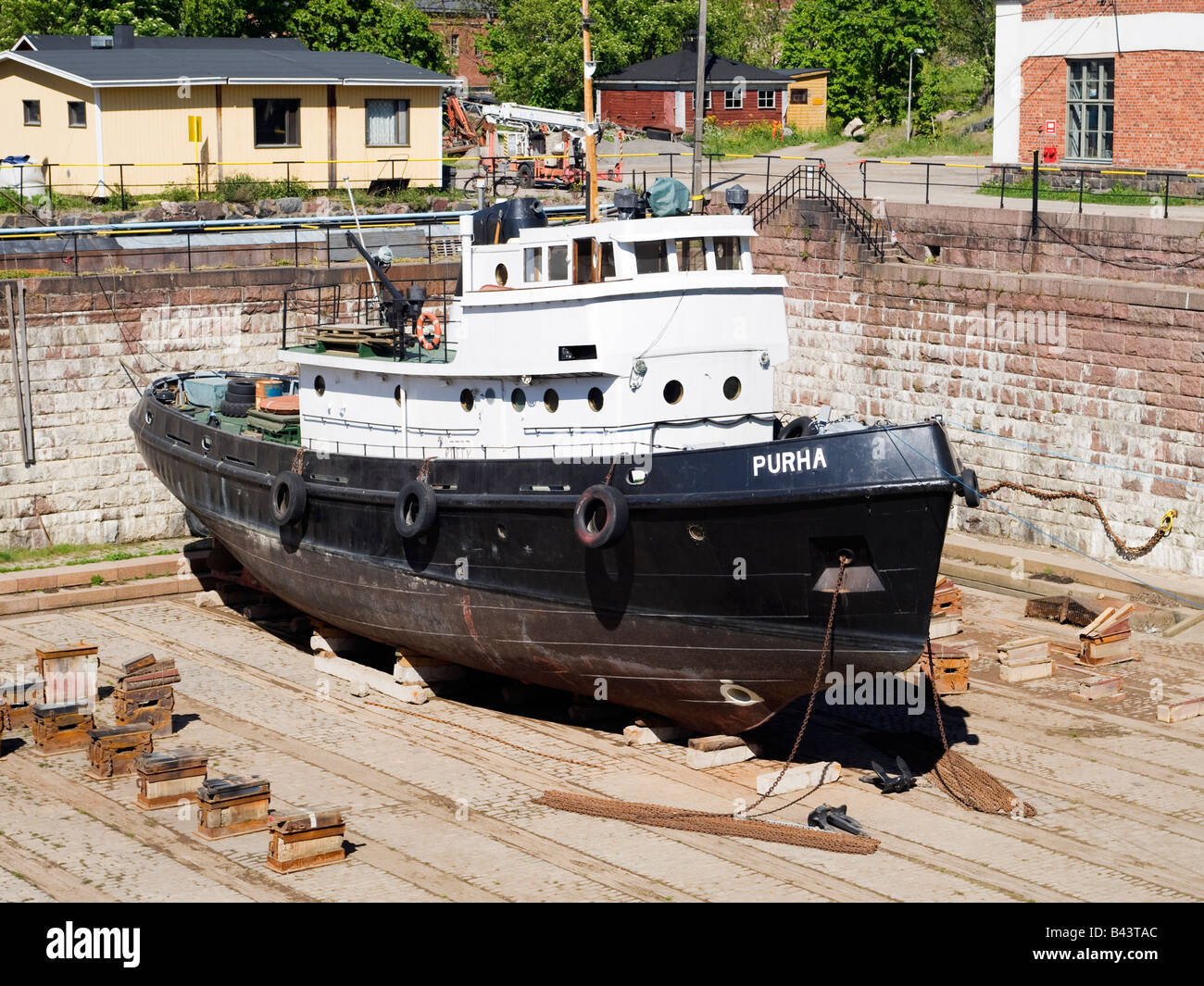 Tug boat in historic drydock (1750) at Suomenlinna shipyard ...