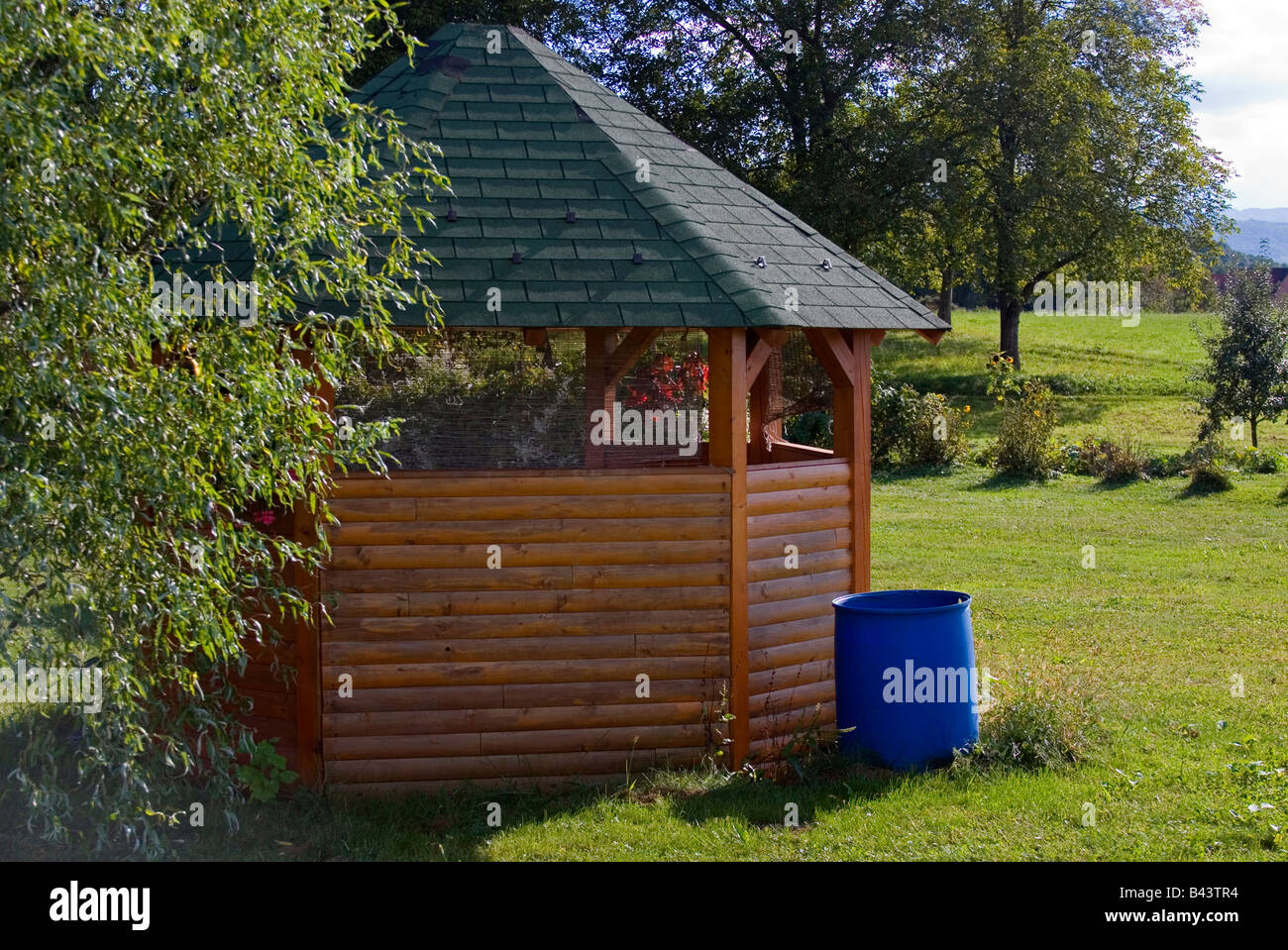 Wooden garden hut in shape of octagon Stock Photo - Alamy