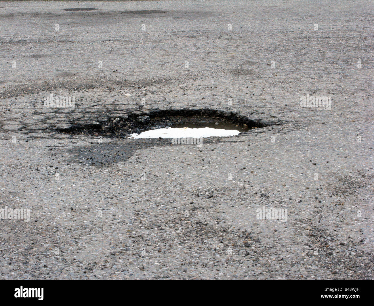 Pothole in the road Stock Photo - Alamy