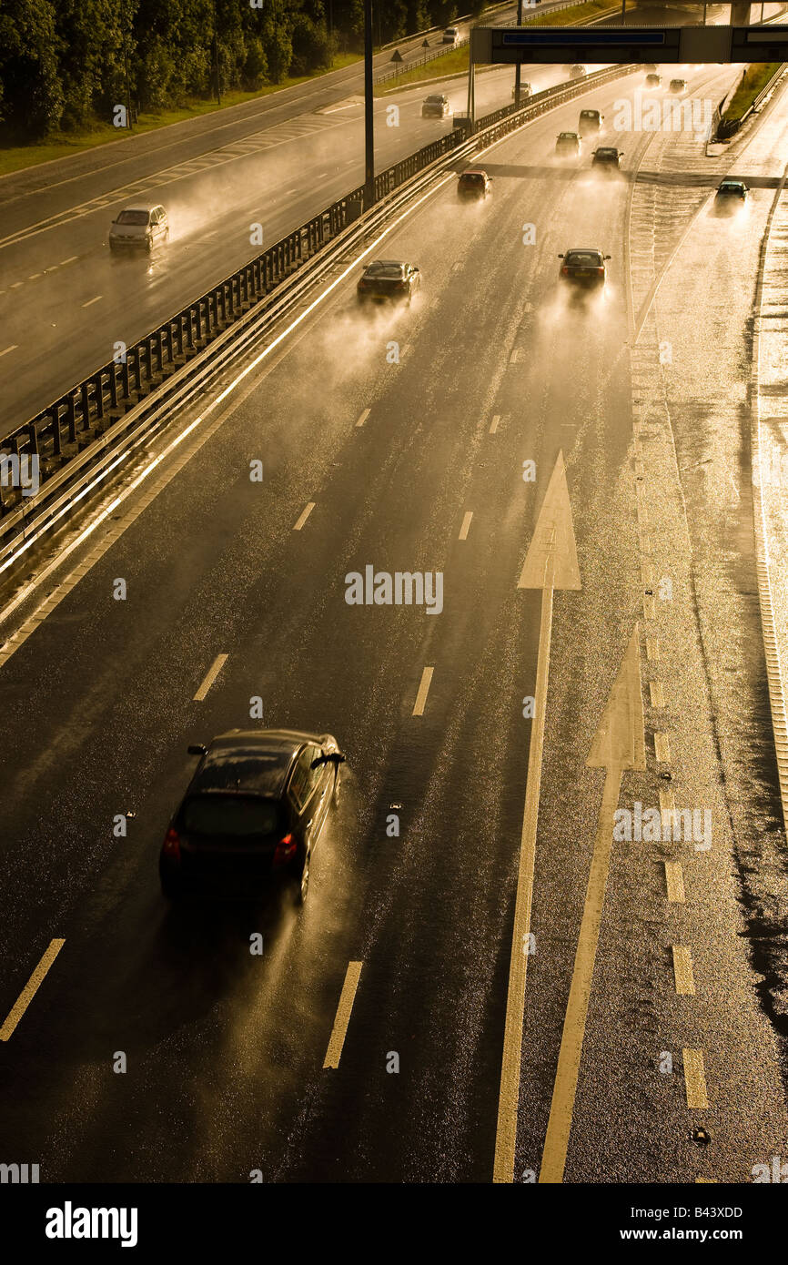 Traffic speeding on a motorway when there is heavy rain and the cars ...