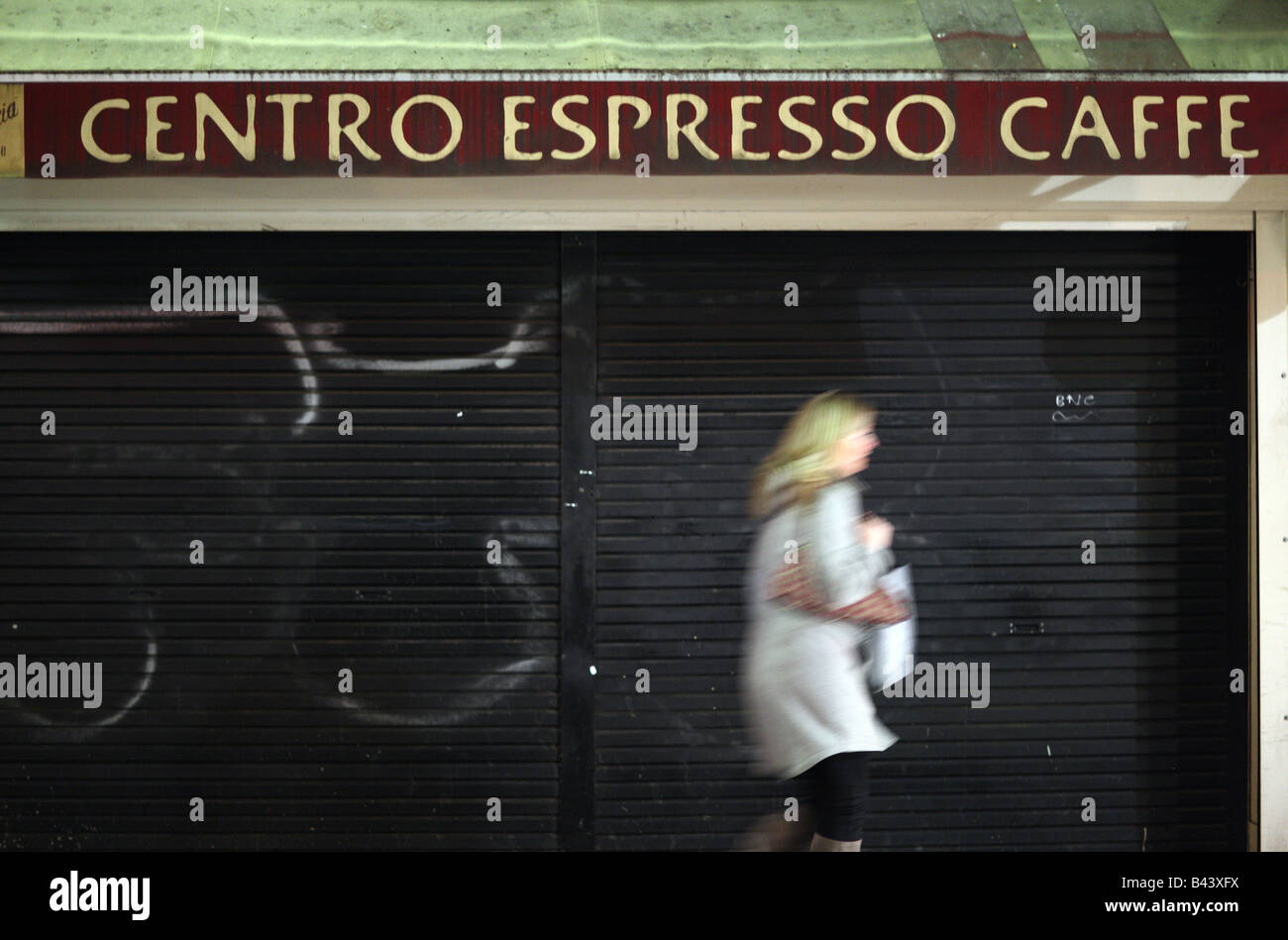 Girl rushing past closed coffee shop Stock Photo - Alamy