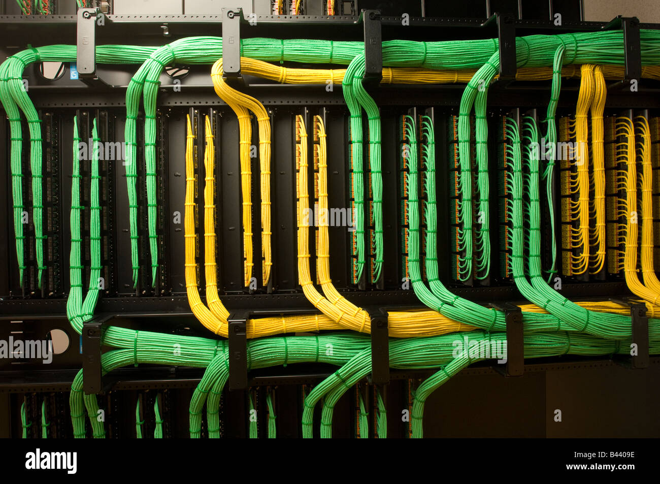 Bundles of yellow and green computer wires at data center computer ...